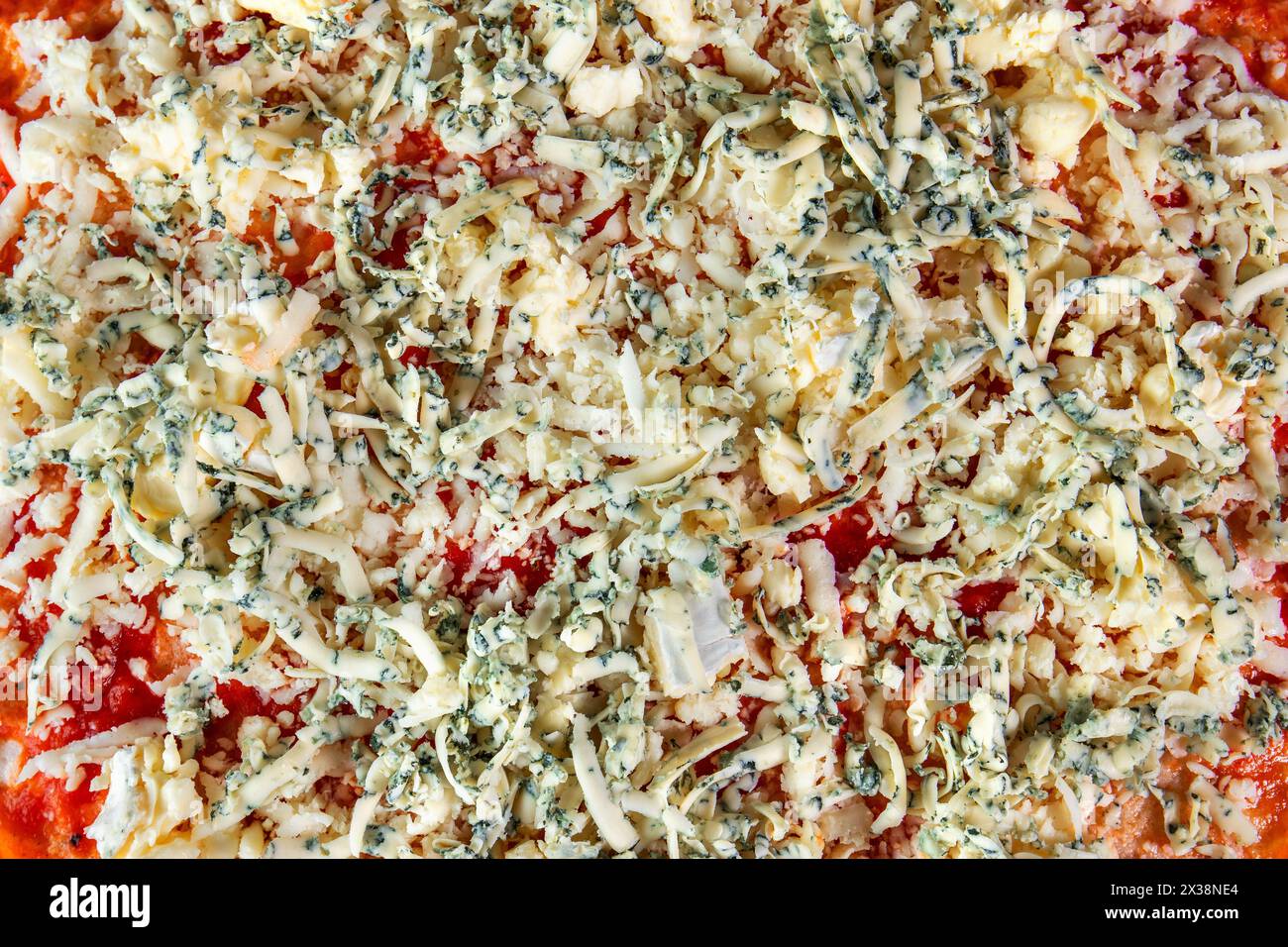 A tantalizing close-up view of a pizza prepared for the oven ...