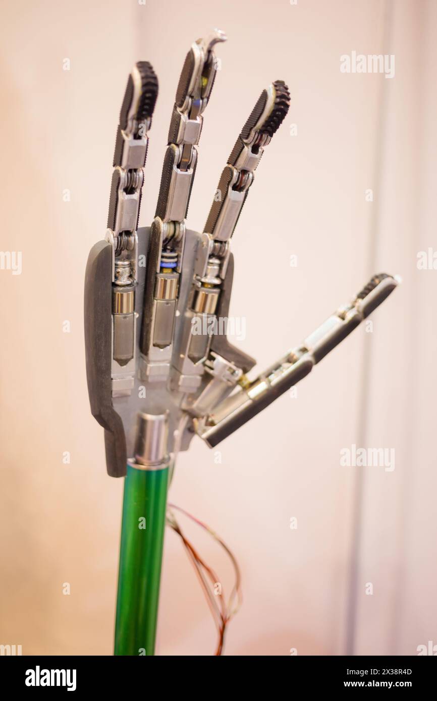 Metal robotic hand with four fingers with mechanical joints, close up ...
