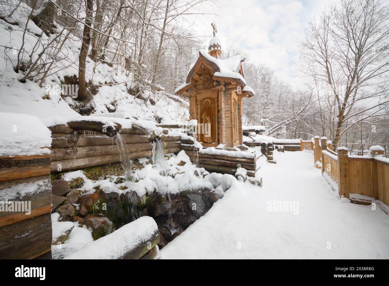 Wooden old-style structure and fountain in Russian Orthodox Monastery ...