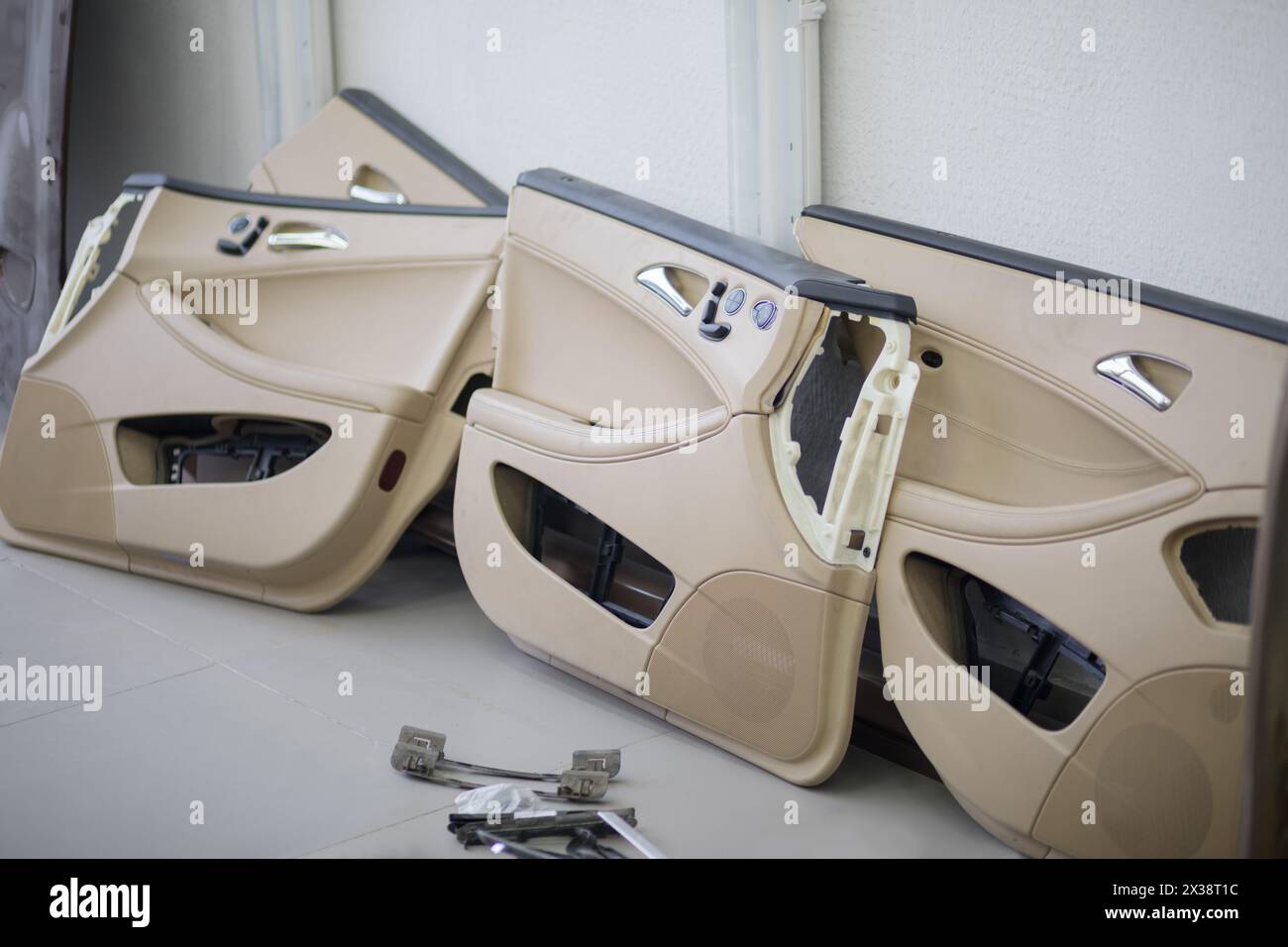 Four doors of modern car and instruments are on floor in empty car ...