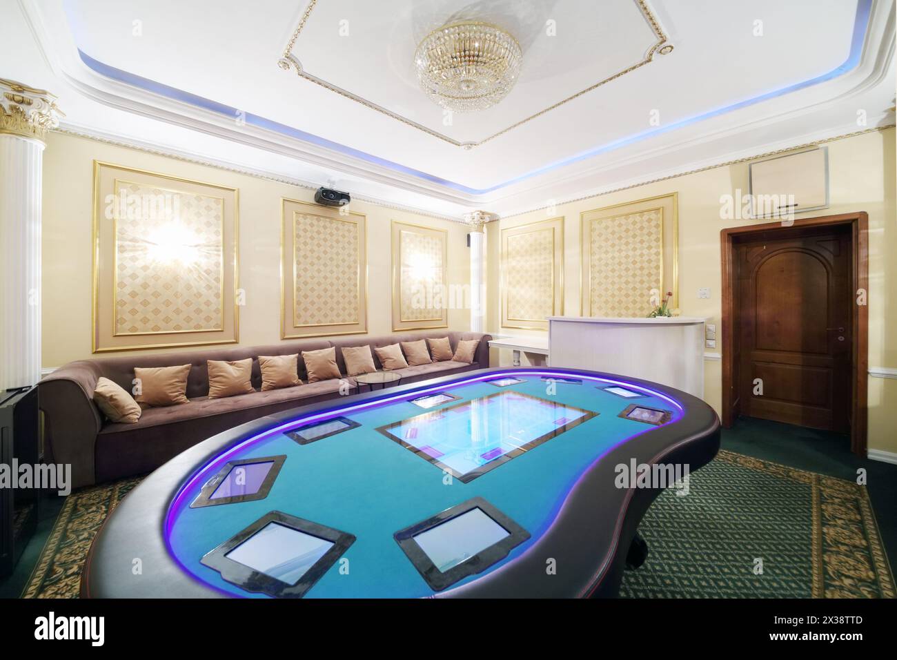 Private empty hall in casino with electronic poker table and soft couch ...