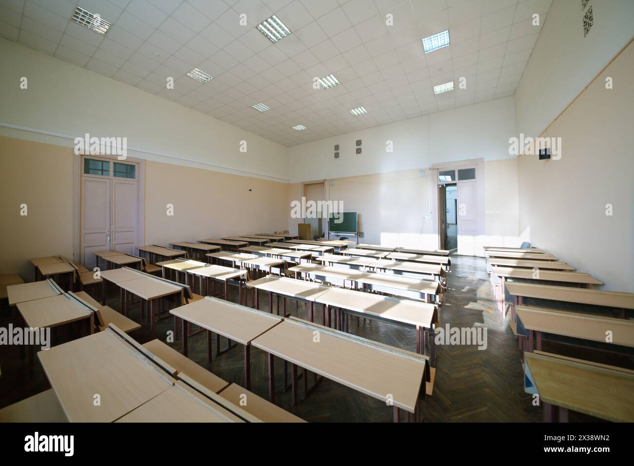 Suuny classroom with rows of tables for students and big window Stock ...