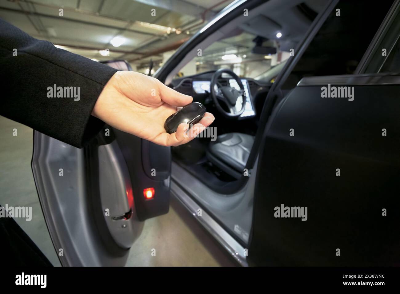 MOSCOW, RUSSIA - NOV 11, 2015: Female hand with remote control of the ...