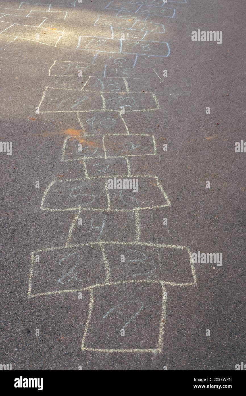 Chalk drawings on asphalt. Hopscotch game concept. Childhood concept ...