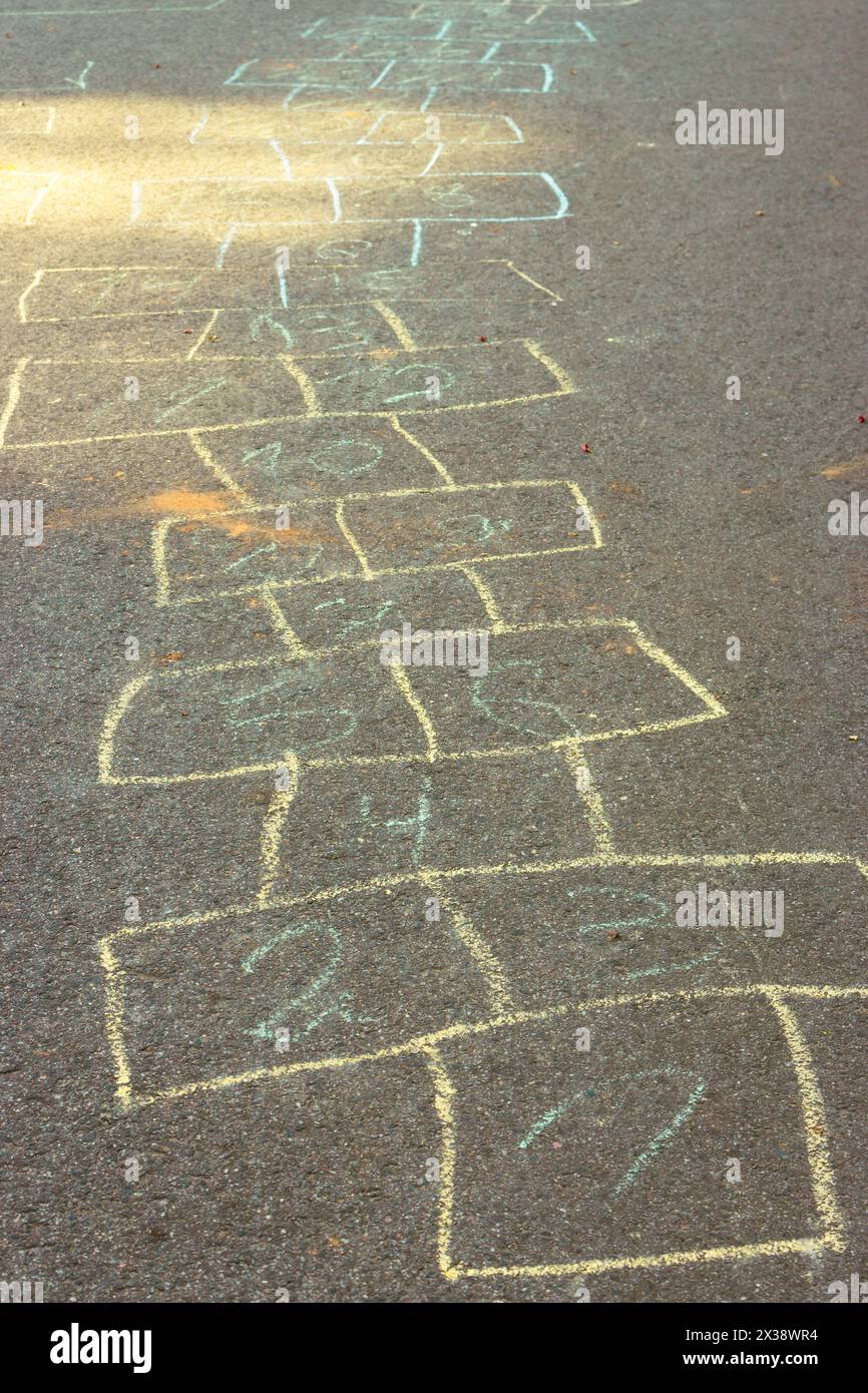 Chalk drawings on asphalt. Hopscotch game concept. Childhood concept ...