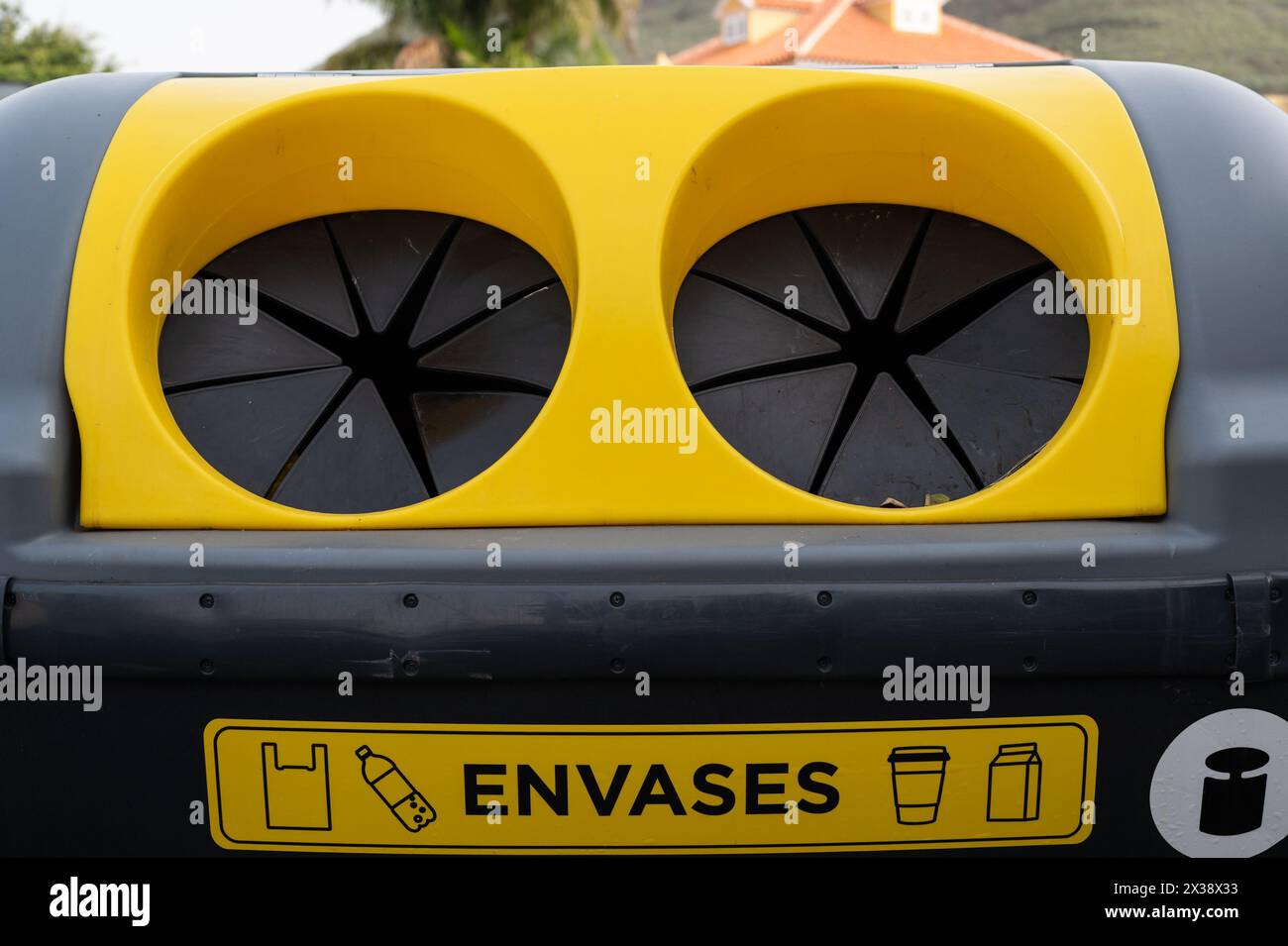 Yellow garbage container to put plastic containers inside to recycle ...