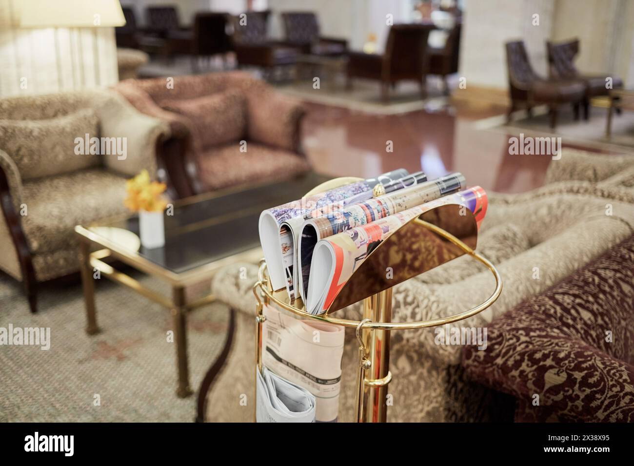Press rack with magazines and newspapers in hotel hall Stock Photo - Alamy