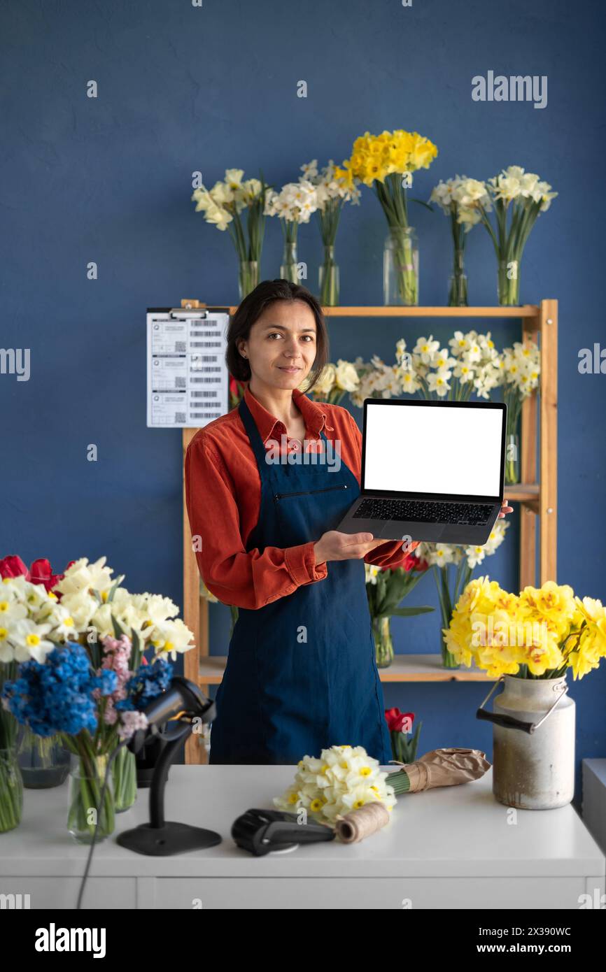 Happy hispanic businesswoman showing laptop mock-up screen while ...
