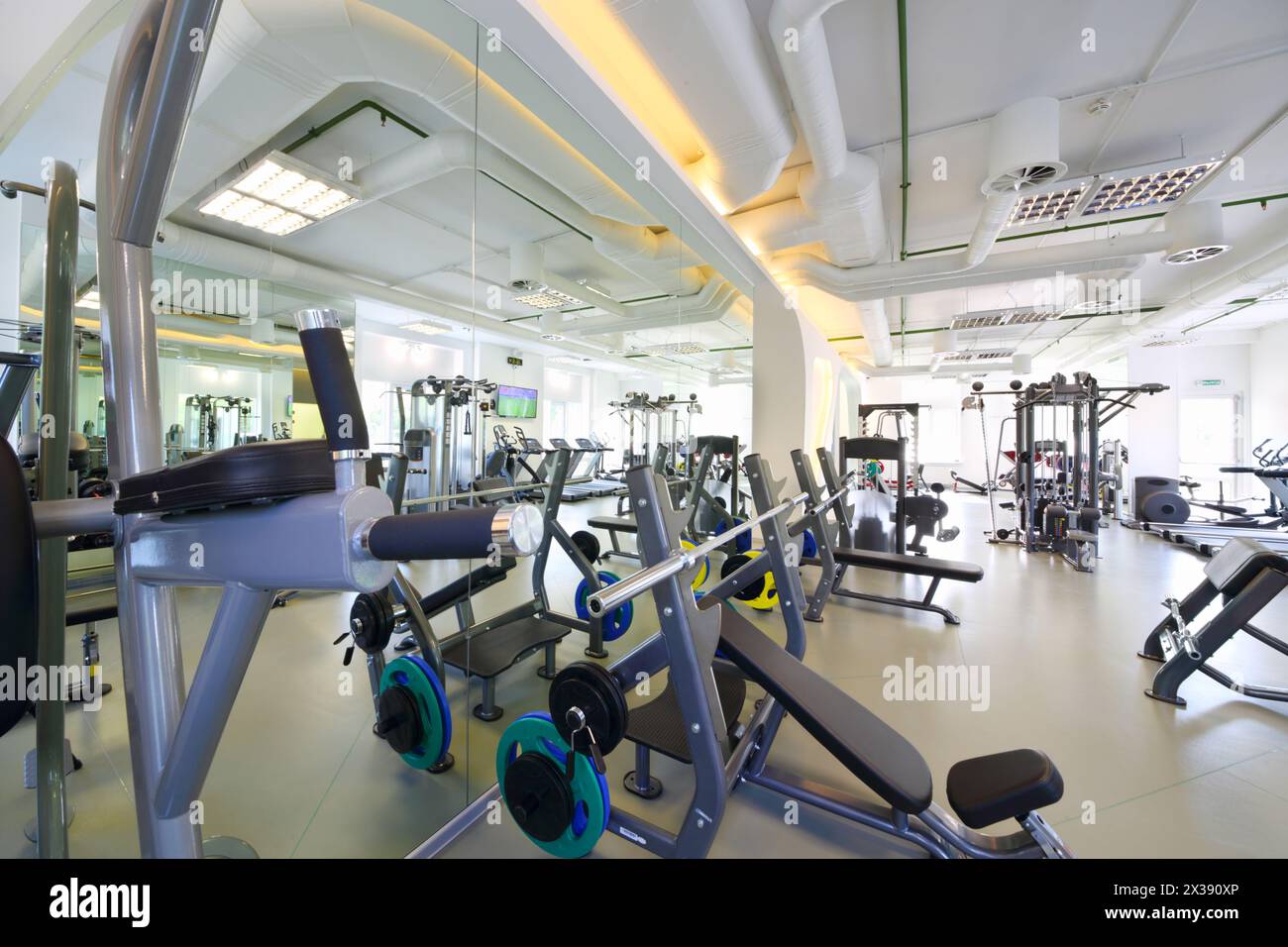 Empty modern gym with new shiny fitness equipment, big mirror for sport ...