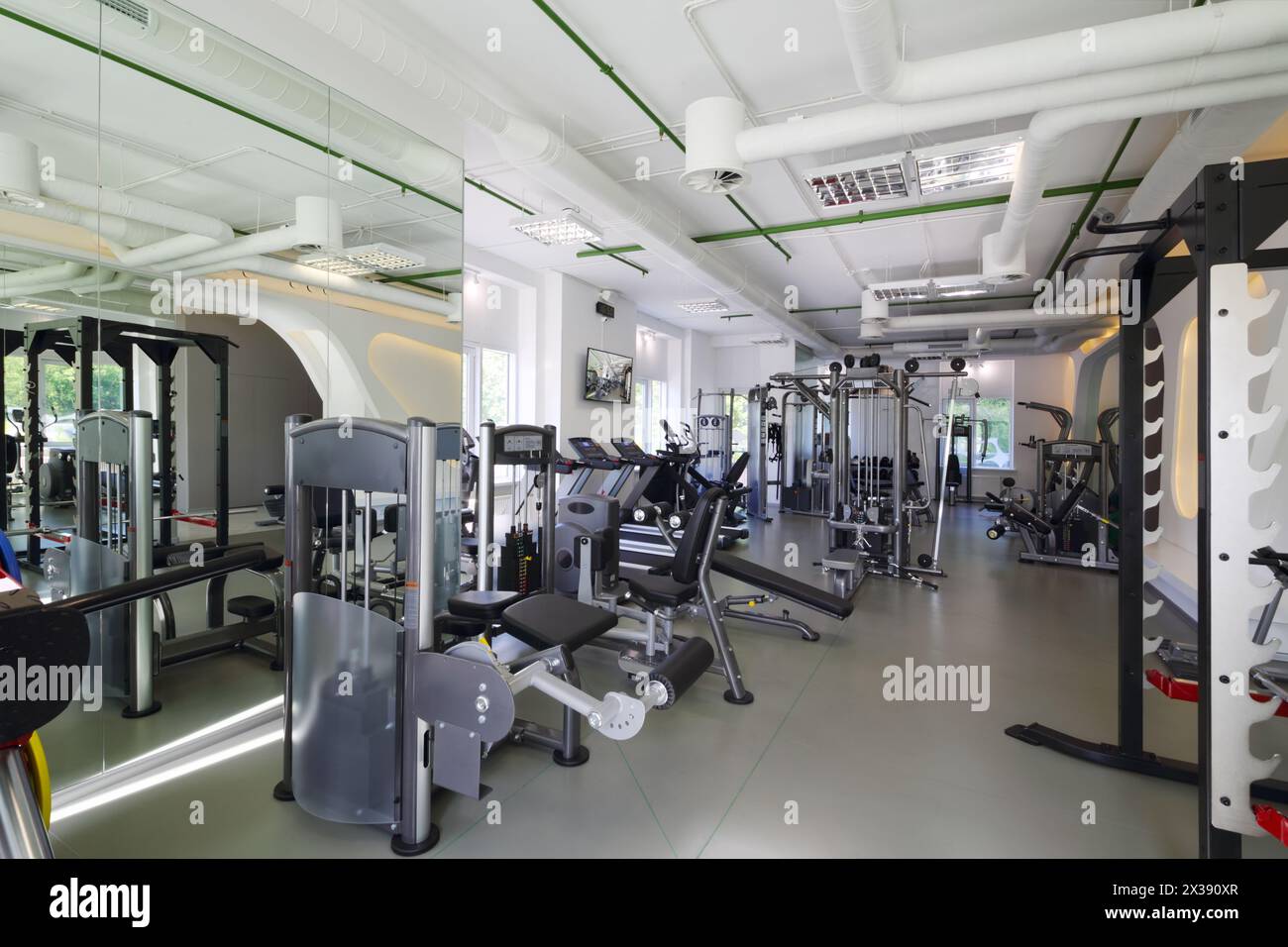 Empty modern gym with new shiny fitness equipment for sport training ...