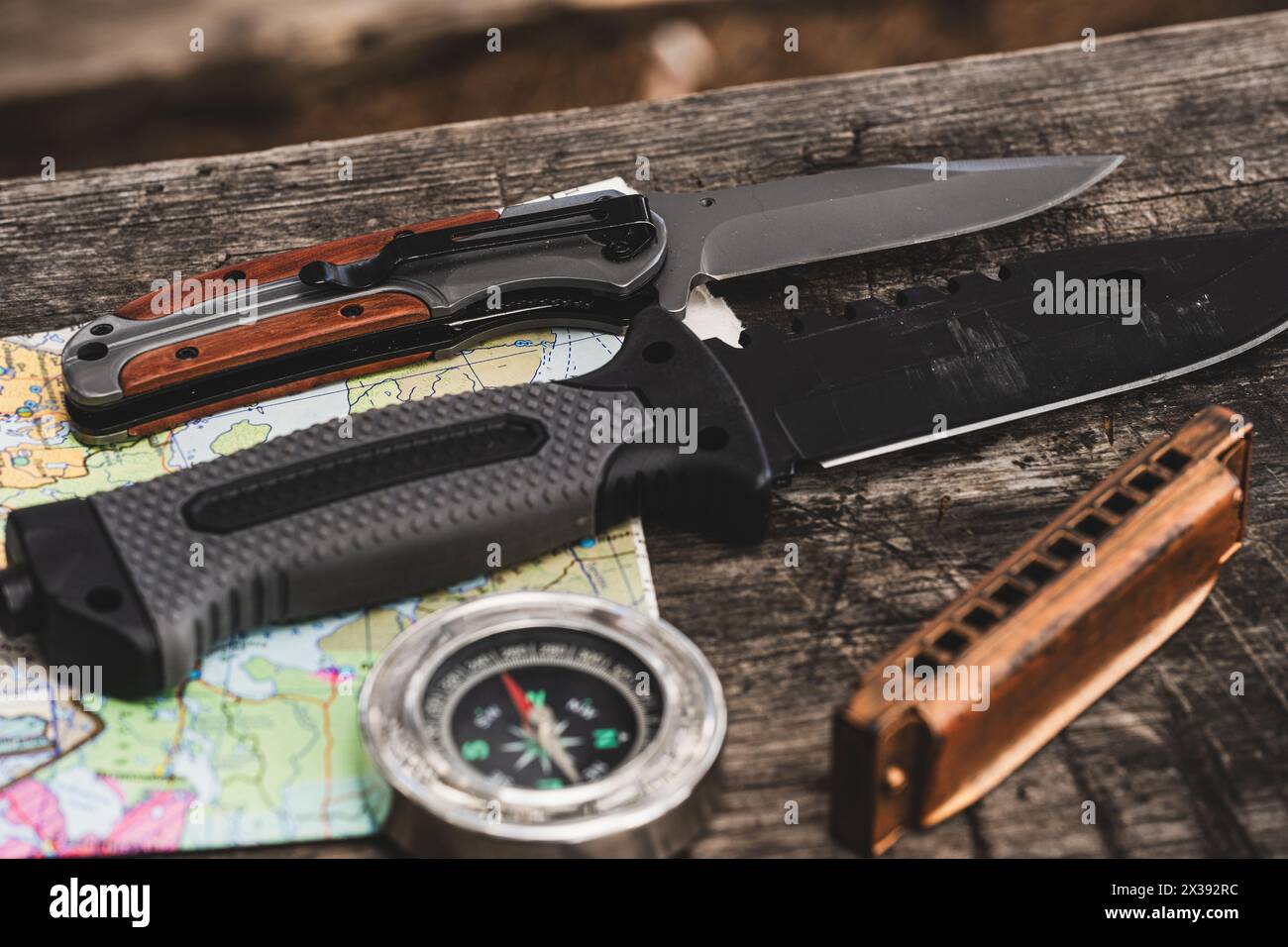 Discover new horizons, knife, compass, harmonica, and map on wooden ...