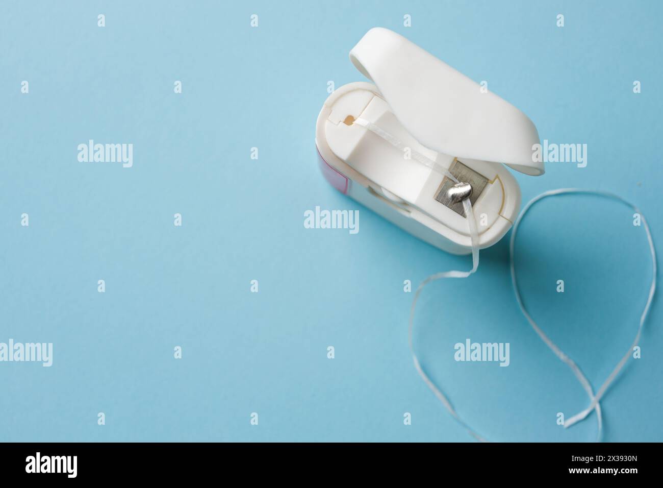 Top view of dental floss in white box on blue background Stock Photo ...