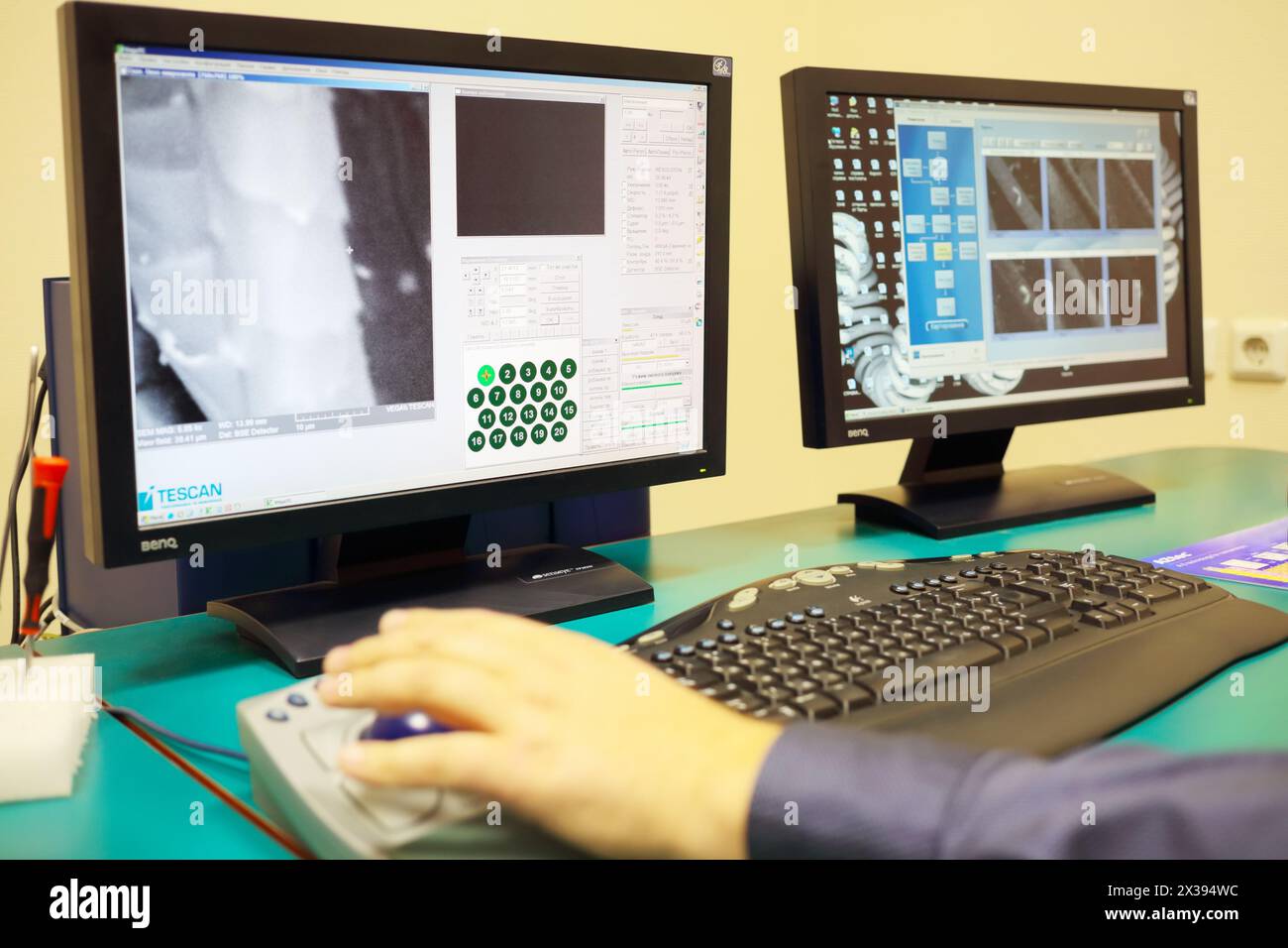MOSCOW - SEP 22, 2016: Hand of man working and hair under microscope on ...