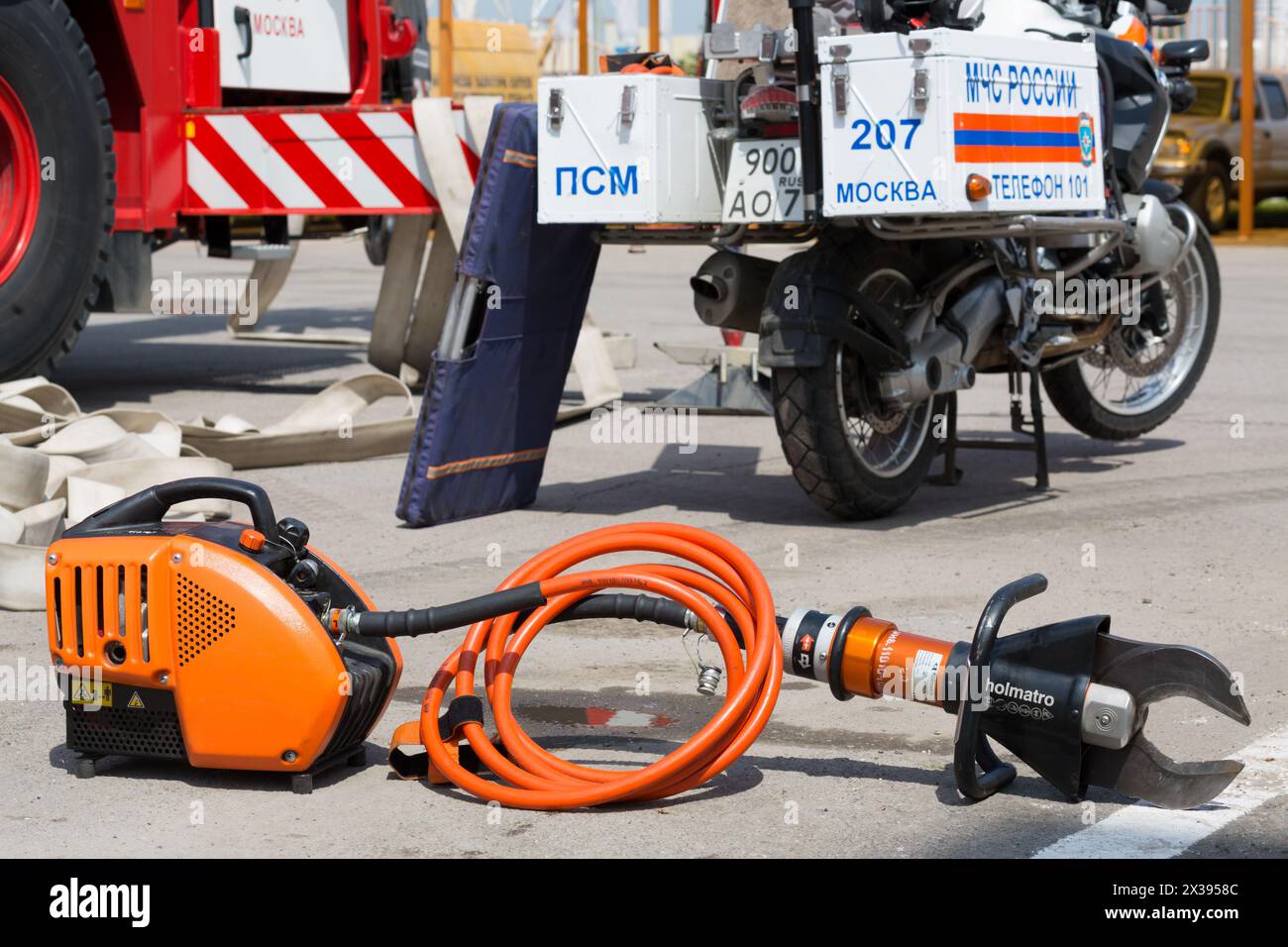 MOSCOW - MAY 29, 2015: Pneumatic clamp near red fire-engine and ...