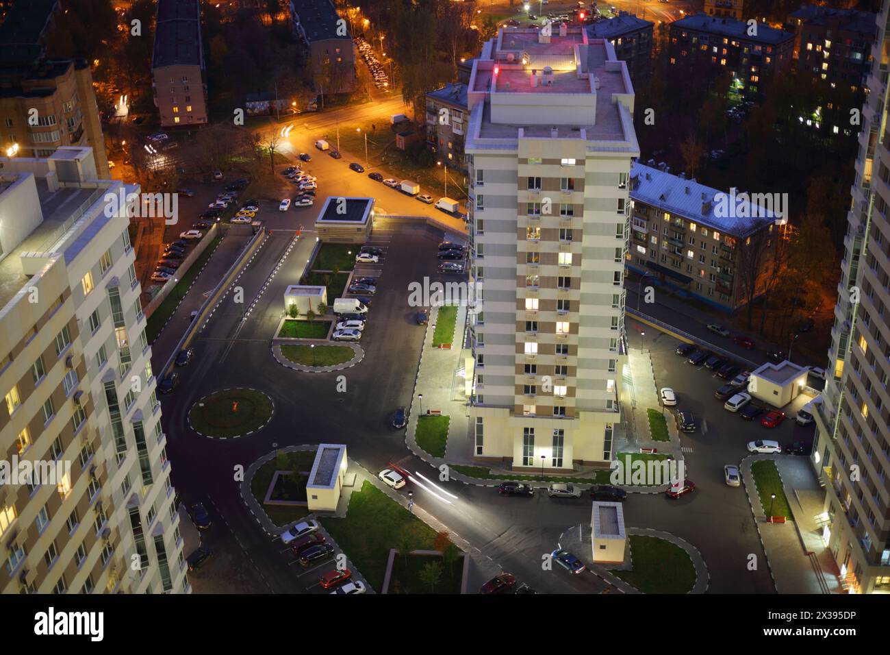 Parking, yard on stylobate in residential complex at summer evening ...