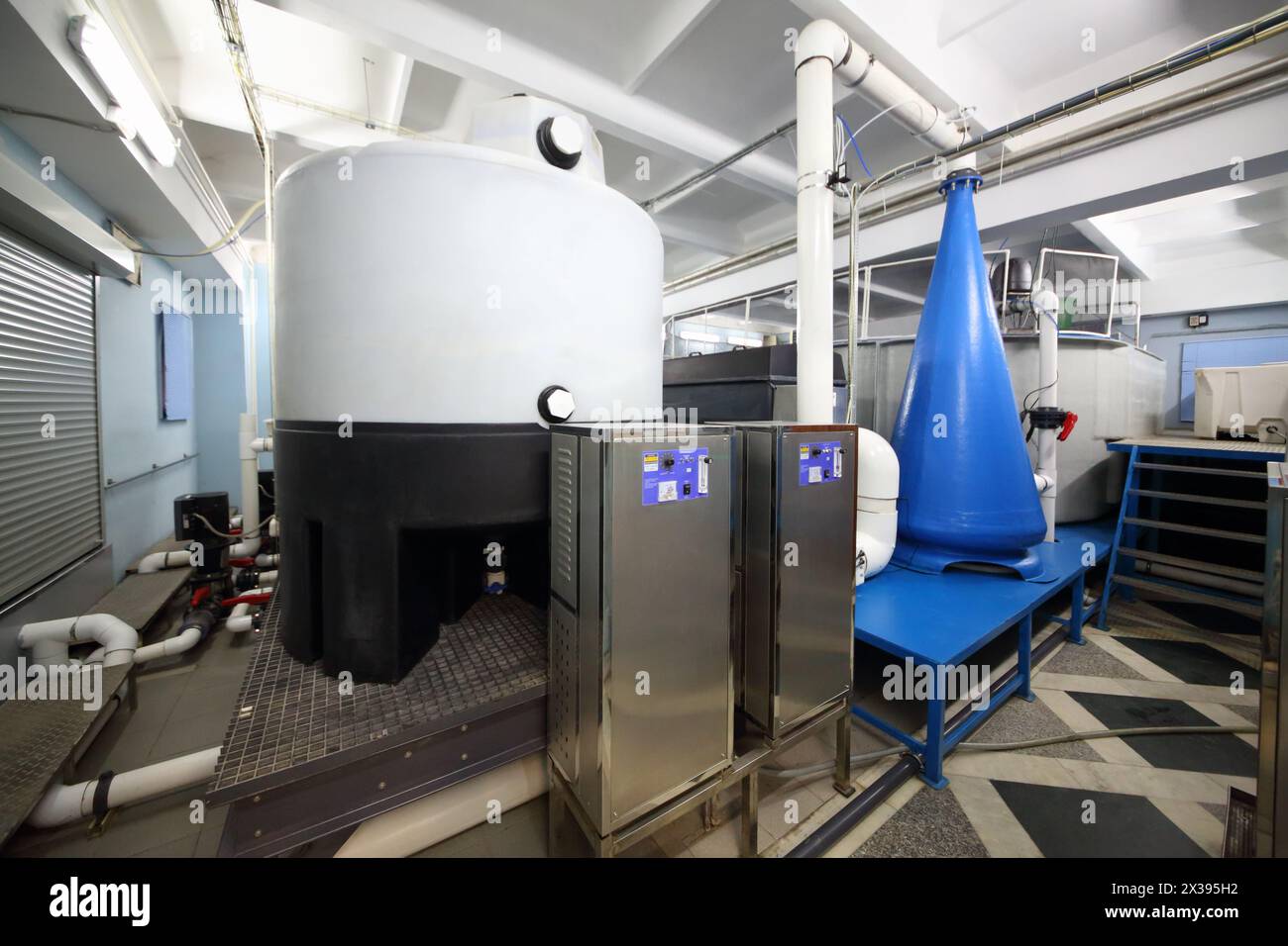 Big storage reservoir with water in empty workshop in fish-packing ...