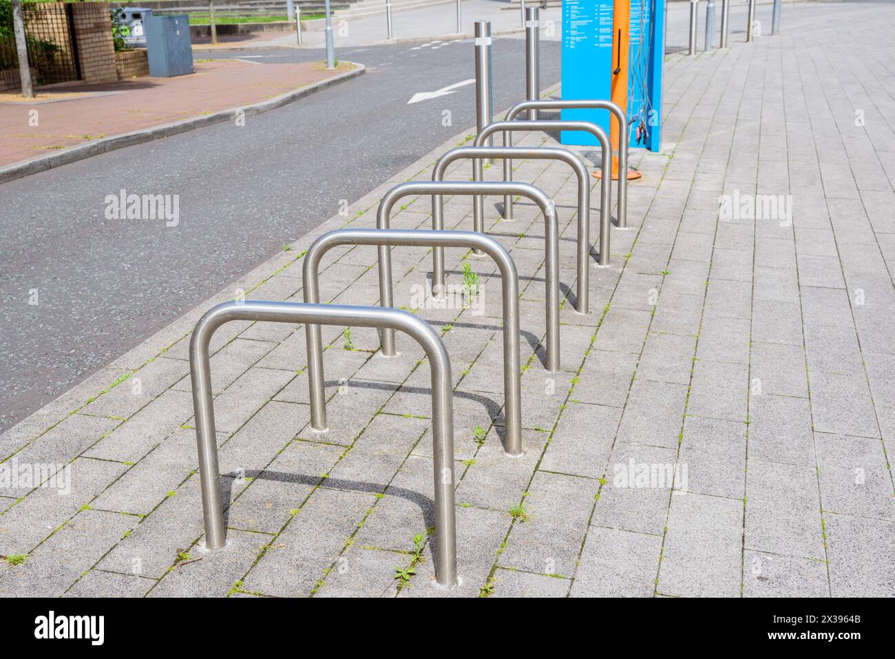 Empty bicycle racks on a stone pavement along a street Stock Photo - Alamy