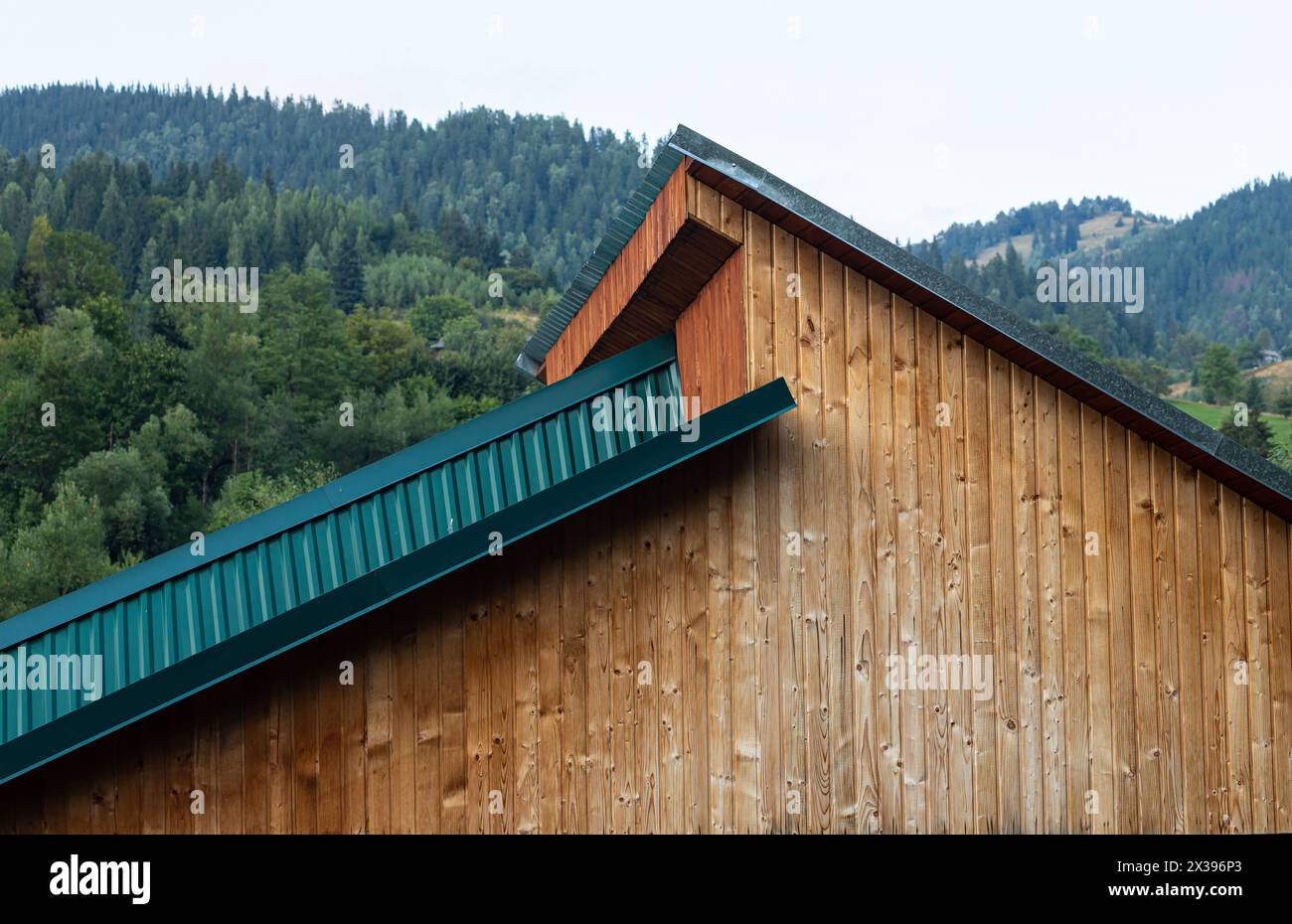 roof covered with metal tiles, roofing, wooden house Stock Photo - Alamy