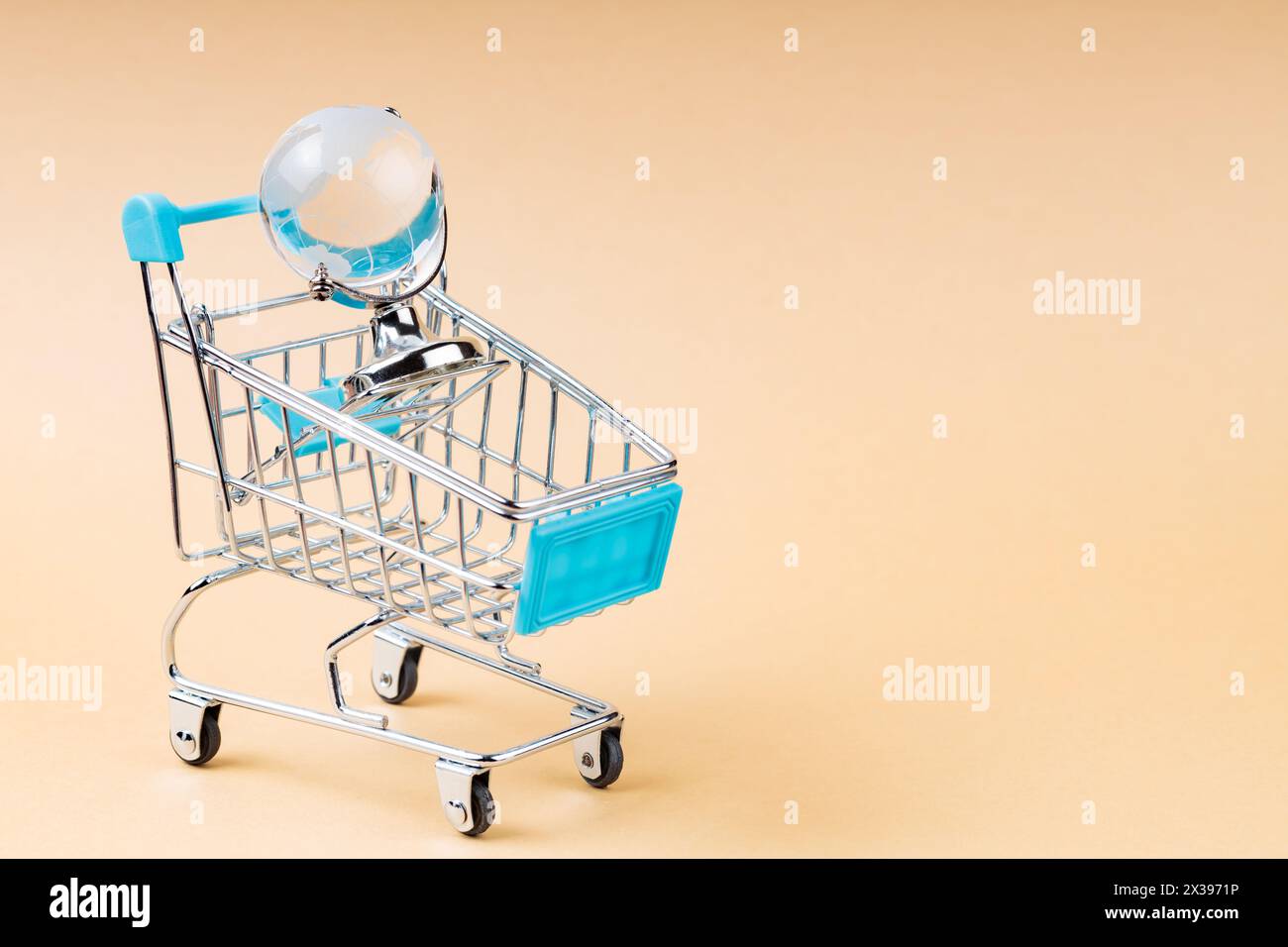 Shopping Cart with Glass Globe on Beige Background, World Trade Concept ...