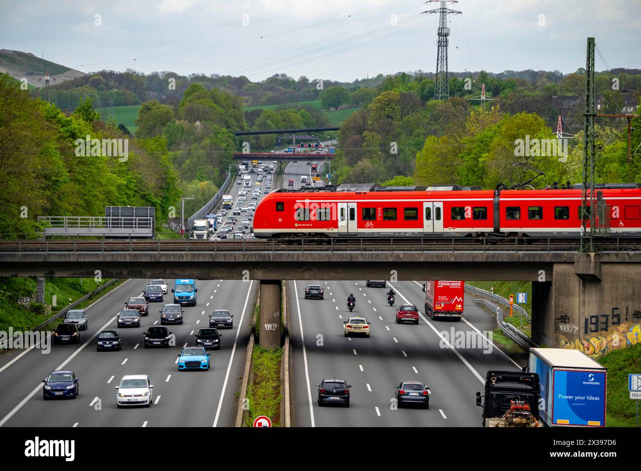 S-Bahn train crossing the highway A3, traffic on 8 lanes, incl. the ...