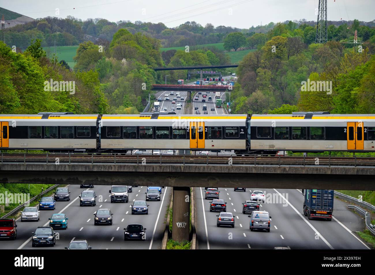 Eurobahn, regional train crossing the highway A3, traffic on 8 lanes ...