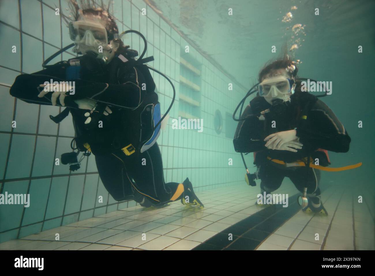 Two young women are diving with equipment in the pool Stock Photo - Alamy