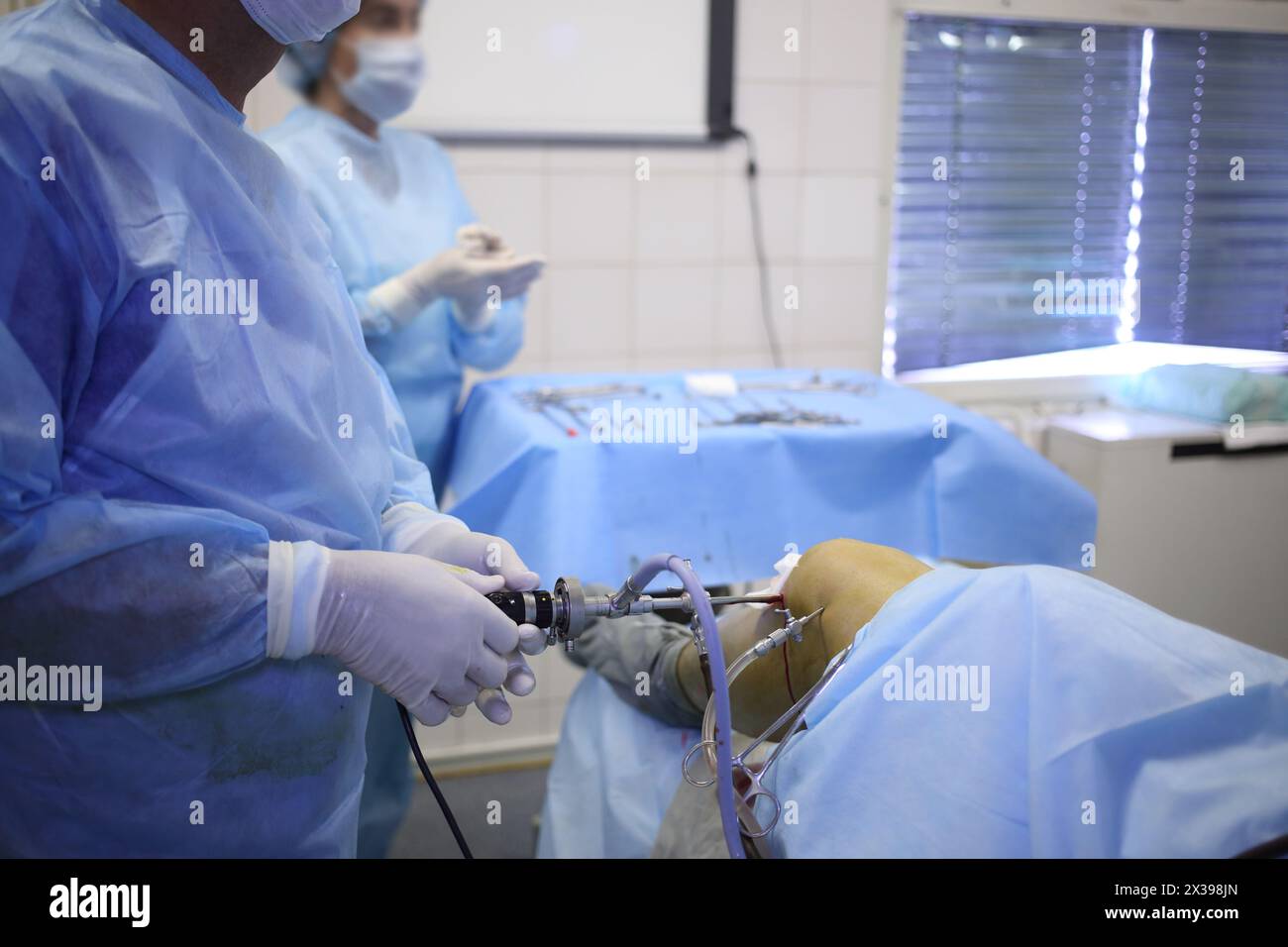 Doctor is doing puncture in knee at the center of endosurgery and ...