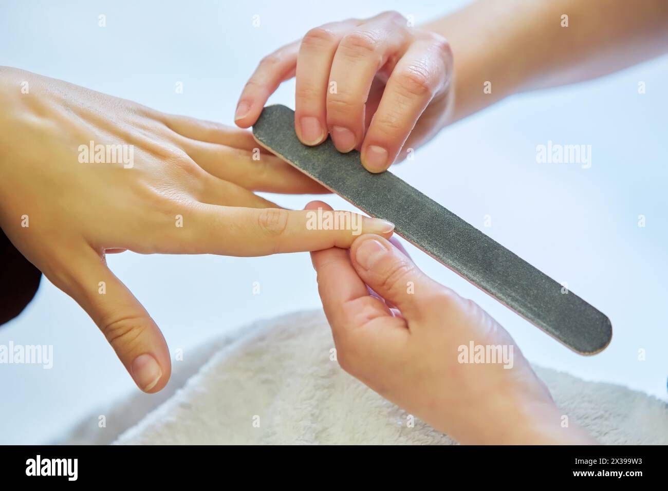 Female hands filing nails hi-res stock photography and images - Alamy