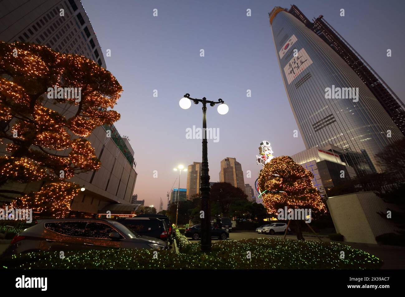 SEOUL - NOV 3, 2015: Illuminated trees, big raccoon and highrise ...