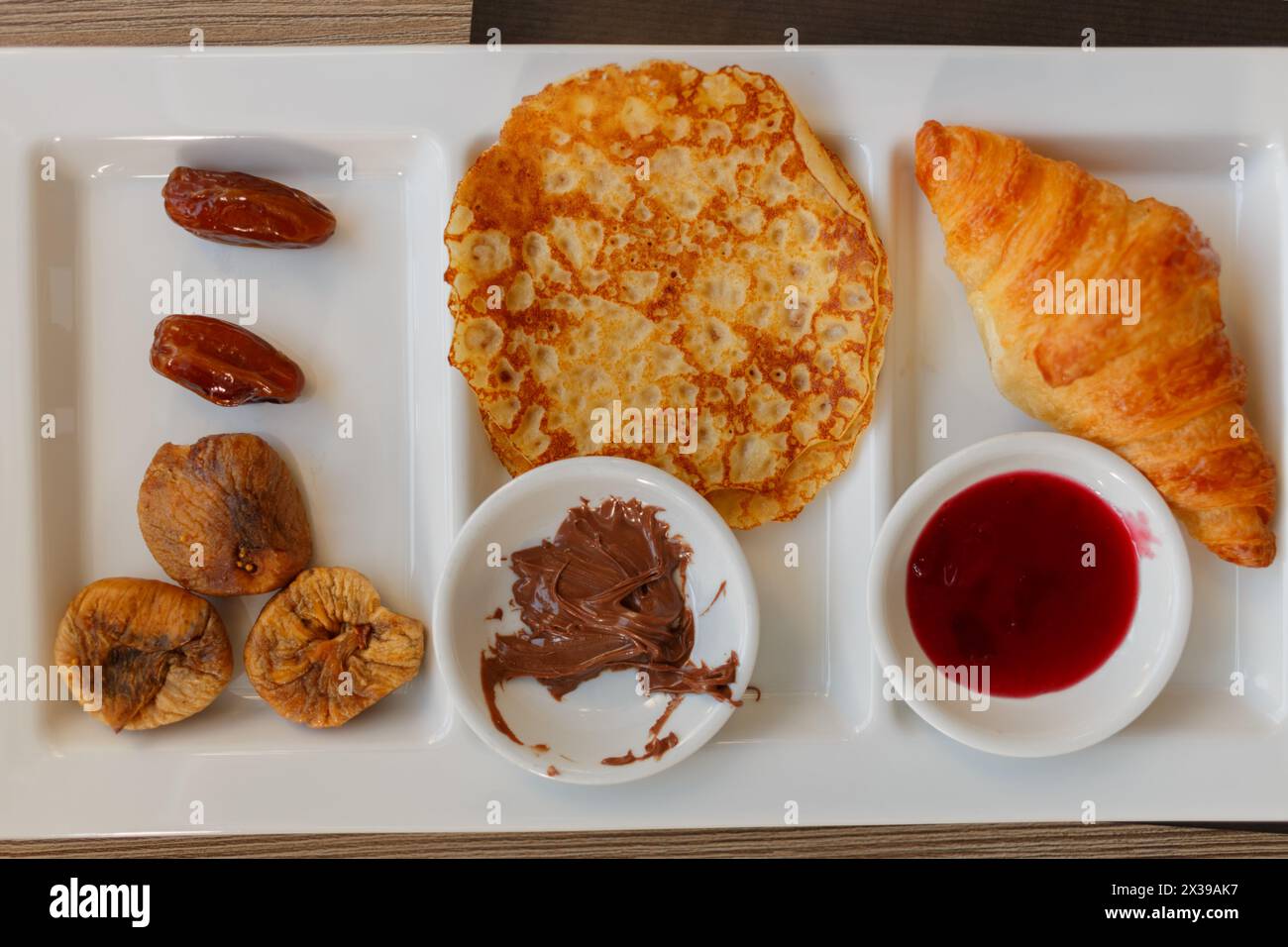 dates, figs, pancake, chocolate, sweet sauce and croissant at ...