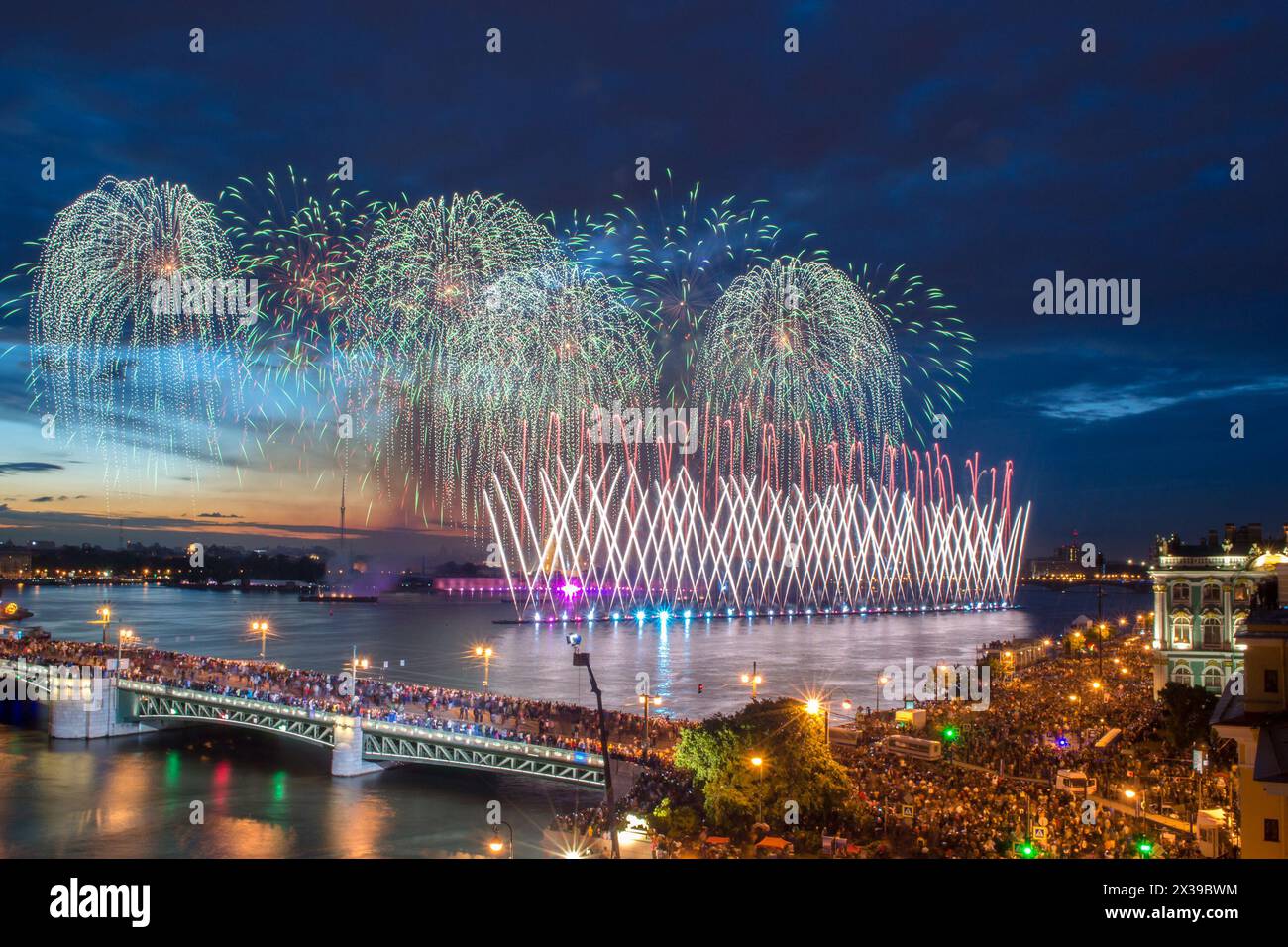 Crowd on Palace Bridge look at beautiful fireworks at dark night in St ...