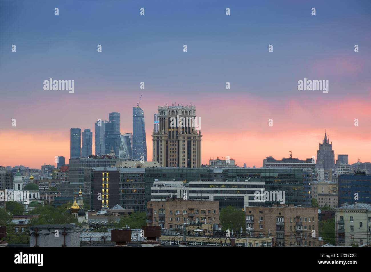 Many roofs, domes of churches and skyscrapers during sunset in Moscow ...