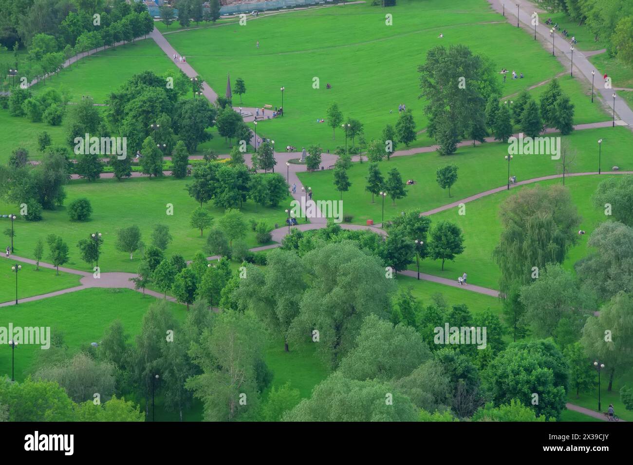People walk in green park in Rostokino area in Moscow, Russia at summer ...