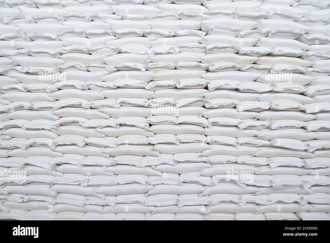 Many rows of plastic white sacks with goods are in big warehouse Stock ...