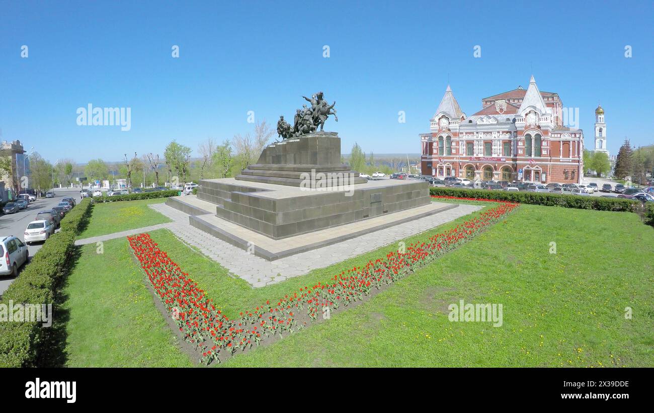 Monument of Chapaev and grassplot with flowers around at spring sunny ...