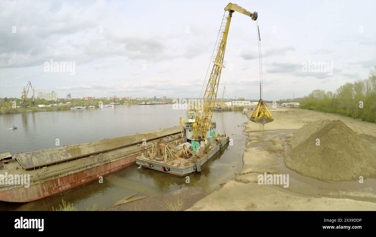 Crane unloads sand from cargo hi-res stock photography and images - Alamy