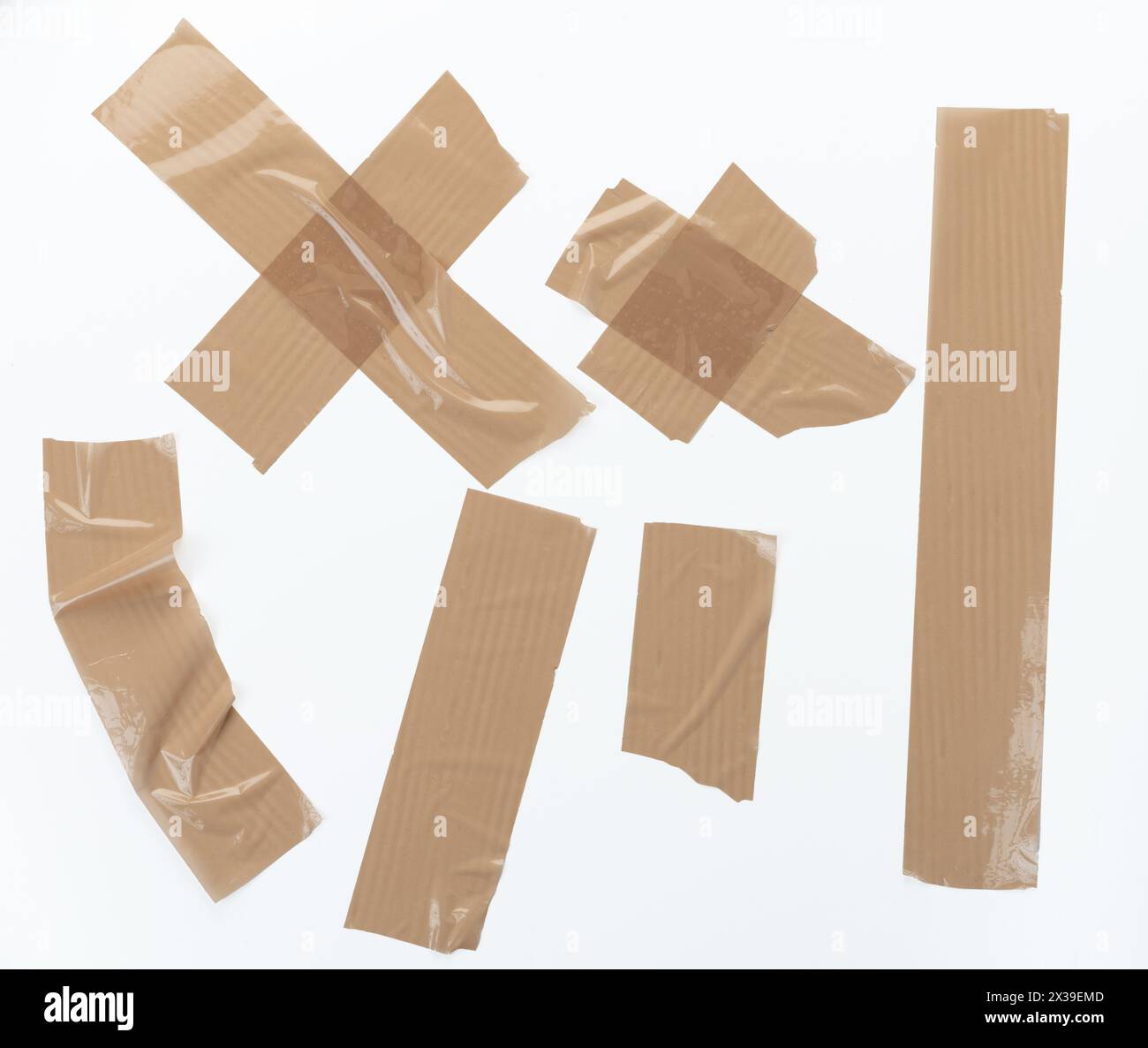Ripped brown plastic tape pieces isolated on white studio background ...