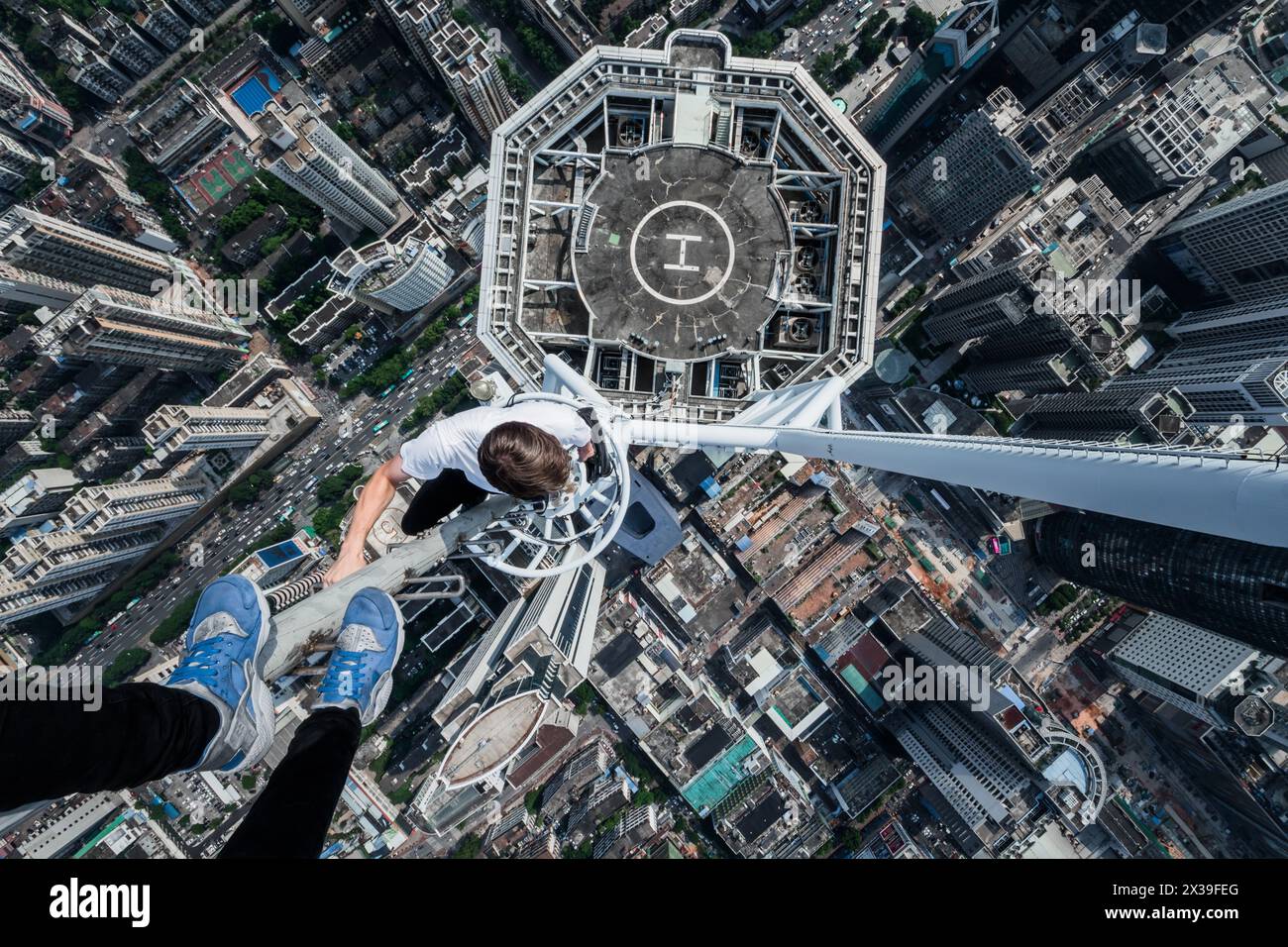 SHENZHEN, CHINA - AUG 25, 2017: Roofers (with MR) on antenna of SEG ...
