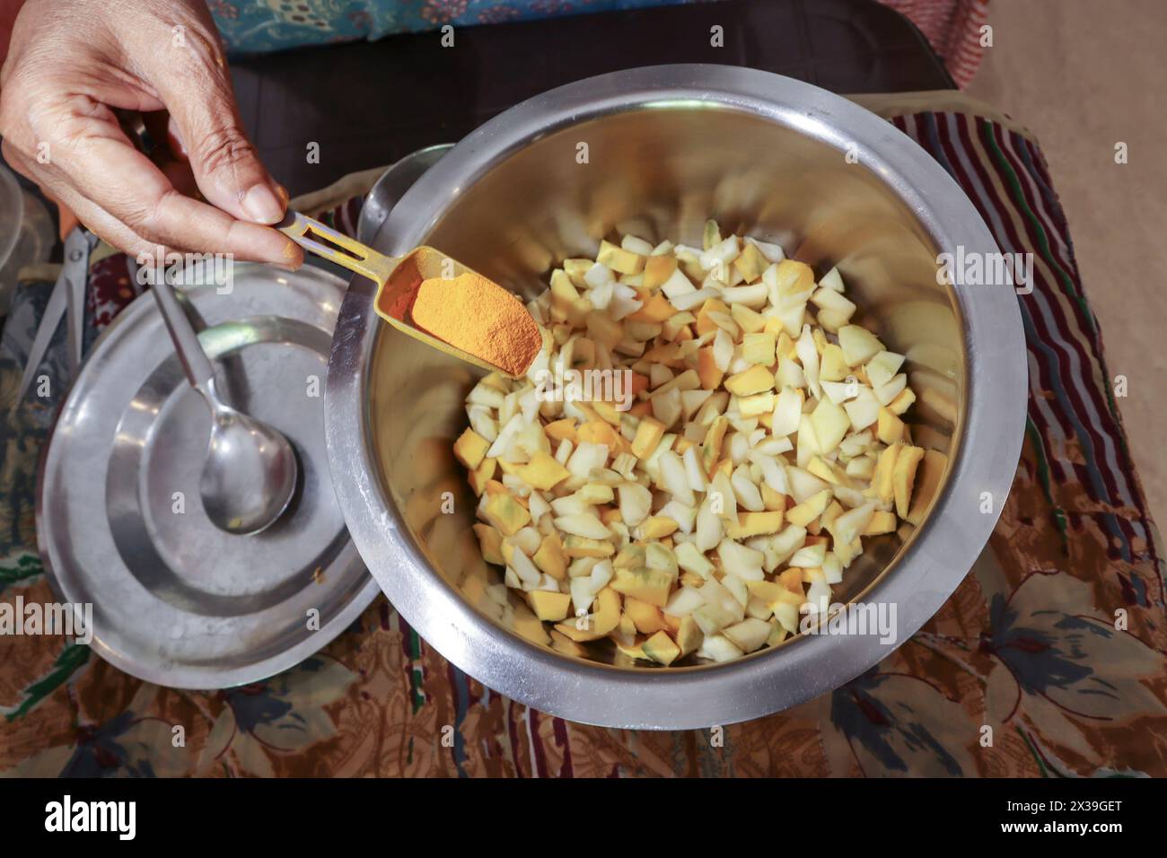 Homemade raw mango pickle making process using mango, red chilly powder ...