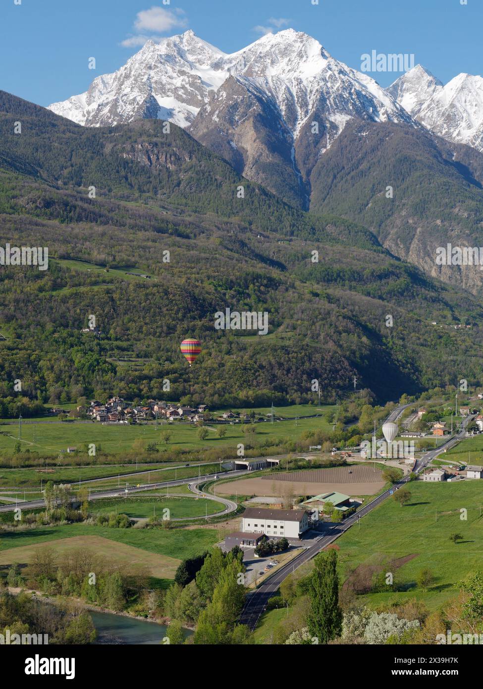 Hot air balloon with snow capped alps behind near the towns of Nus and ...