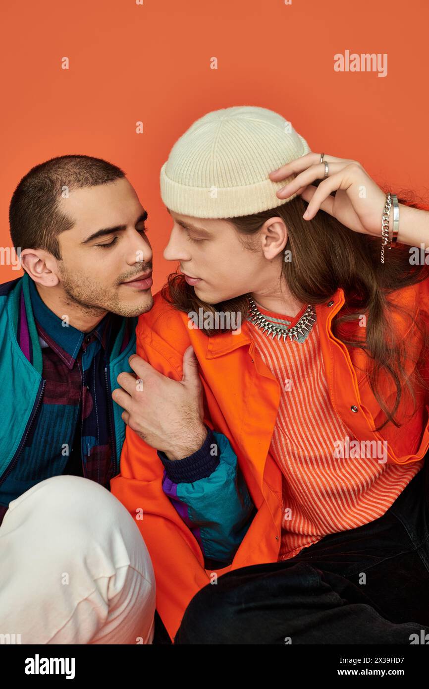 Two men sharing a tender moment on a couch Stock Photo - Alamy