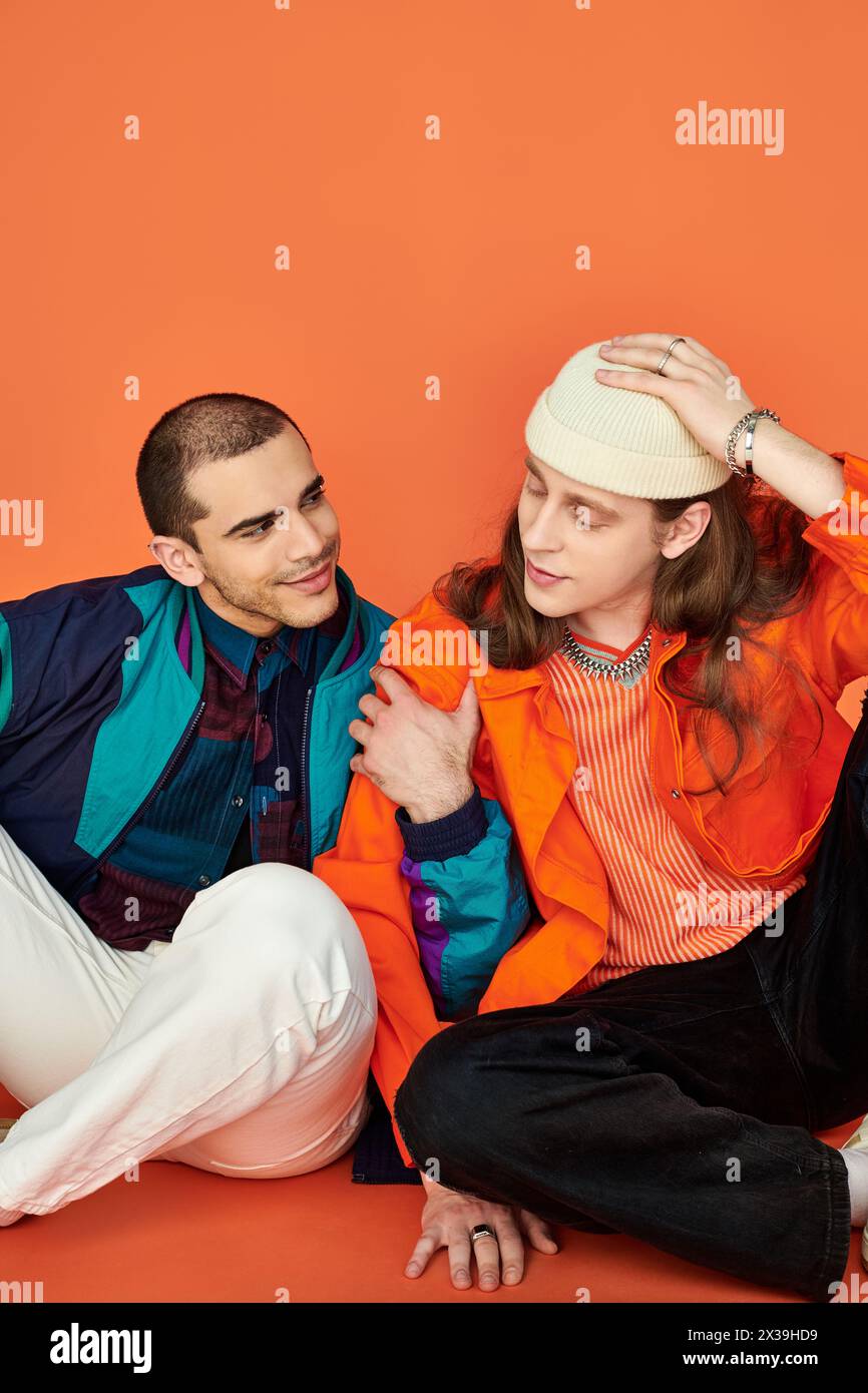 Two men share a tender moment seated closely together Stock Photo - Alamy