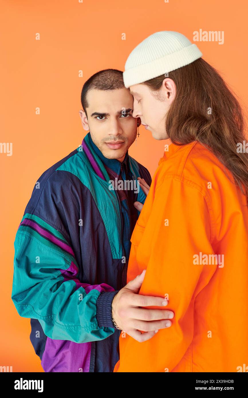 Two men standing affectionately side by side, sharing a tender moment ...