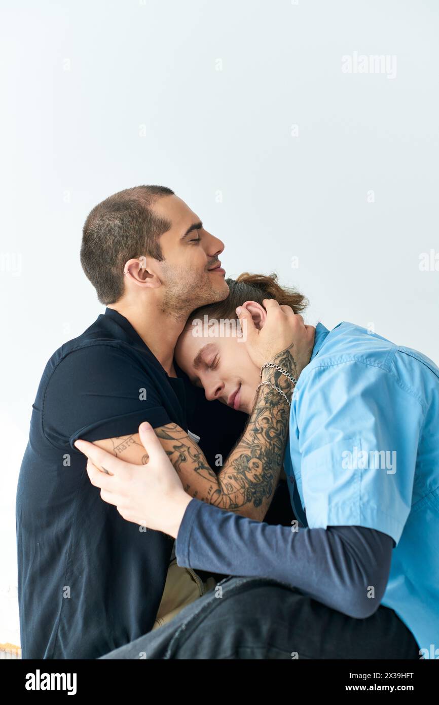 A tender moment between two men hugging each other Stock Photo - Alamy