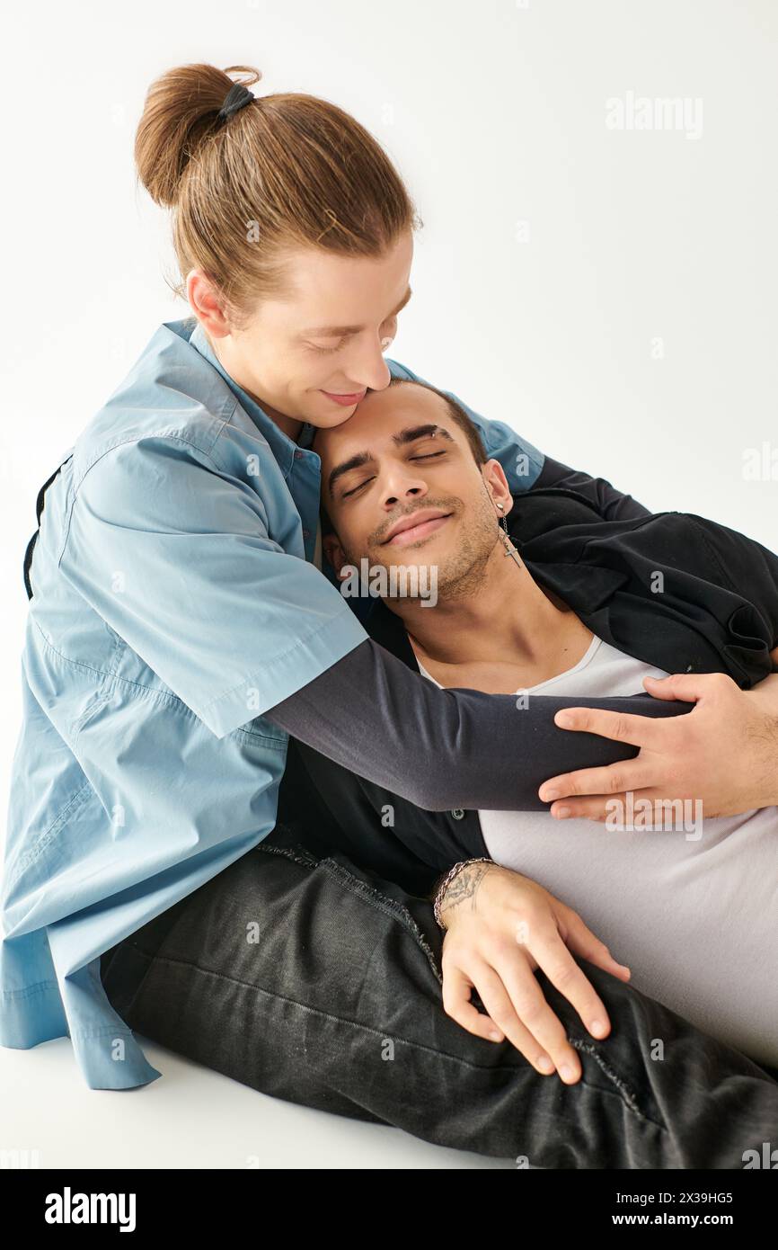 Two men hugging tightly on the floor Stock Photo - Alamy
