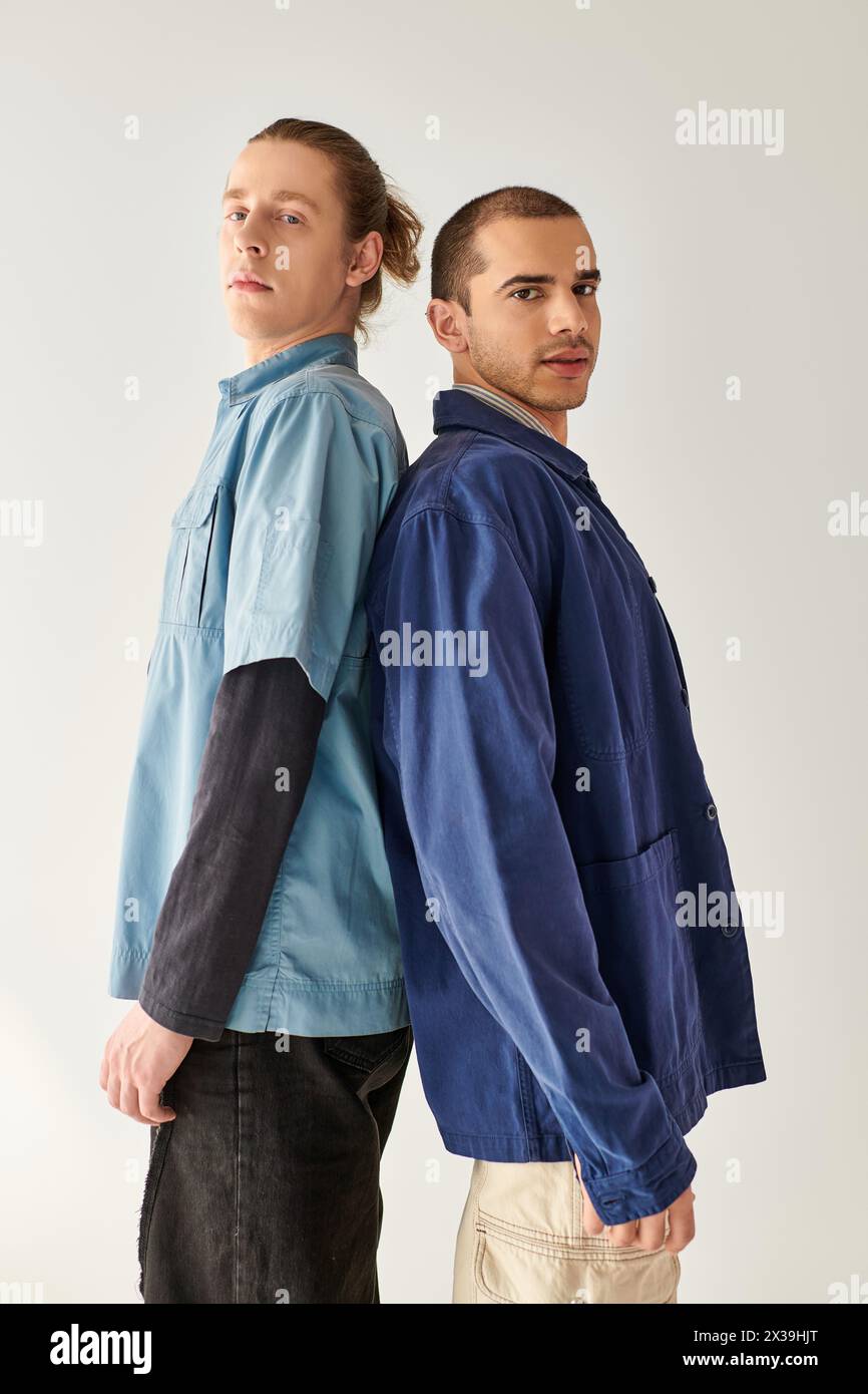 Two young men standing side by side, sharing a moment of connection ...