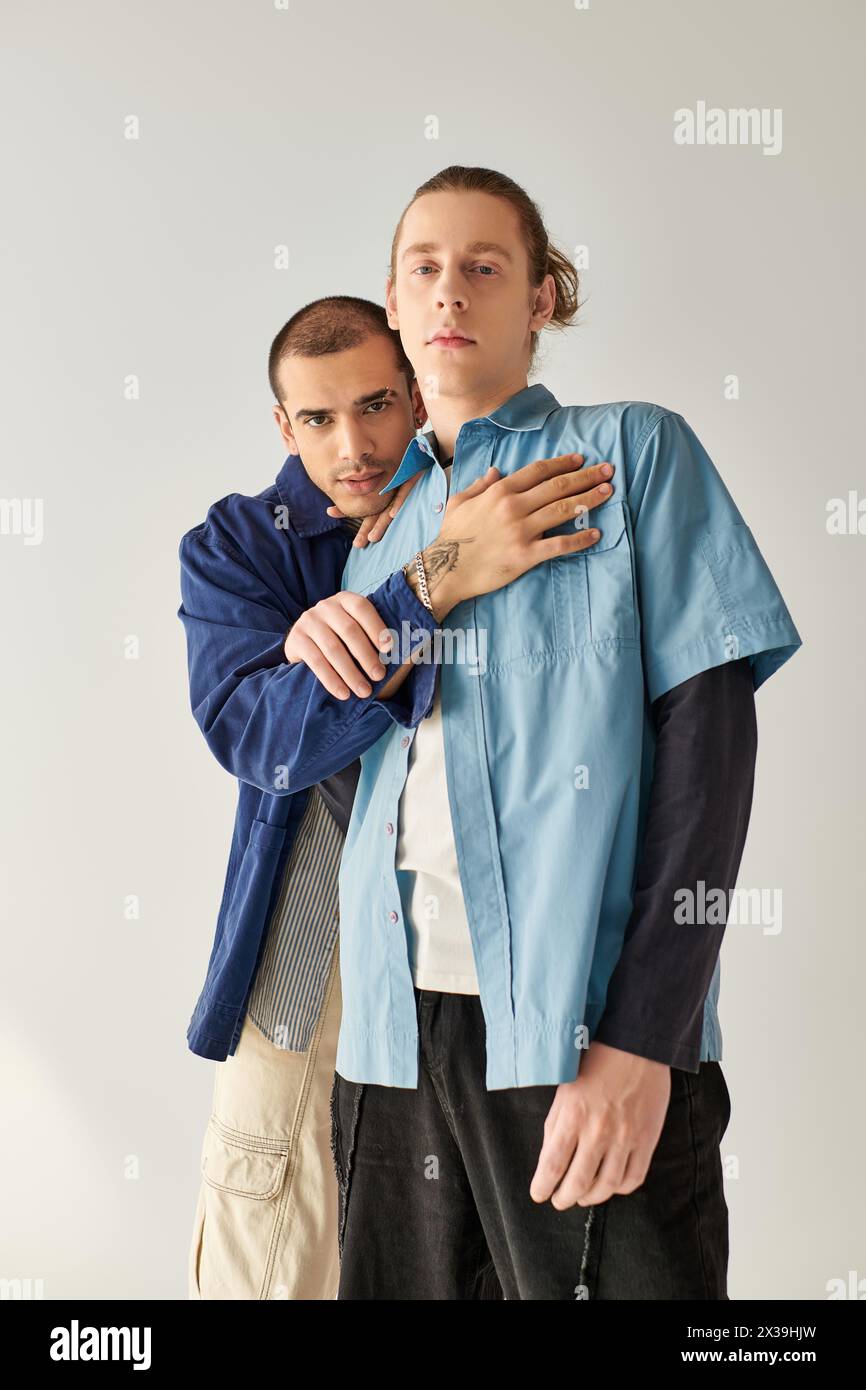 Loving gay couple standing cheek to cheek, arms wrapped around each ...