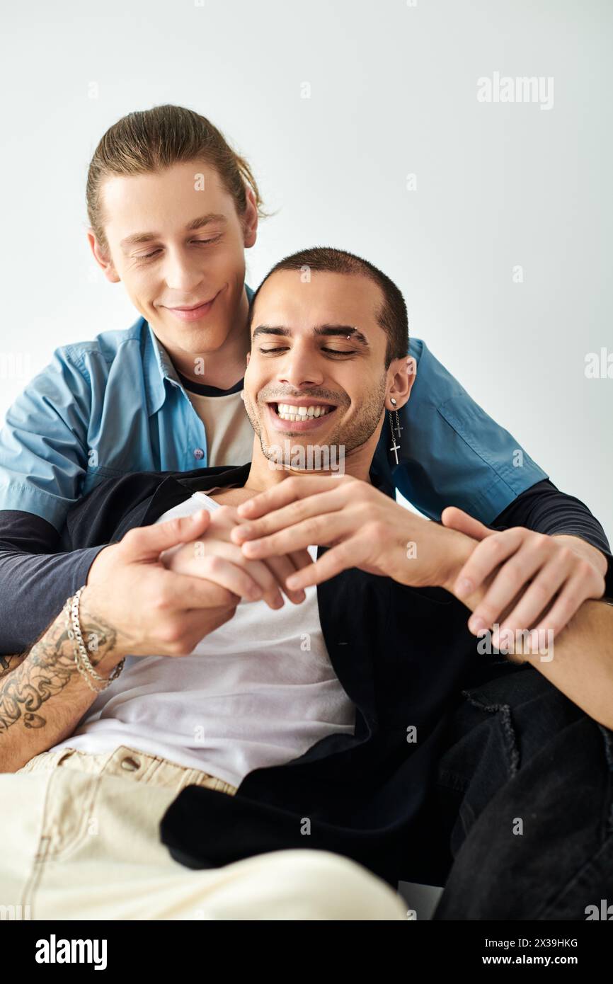 Two men sitting closely, creating a bond Stock Photo - Alamy