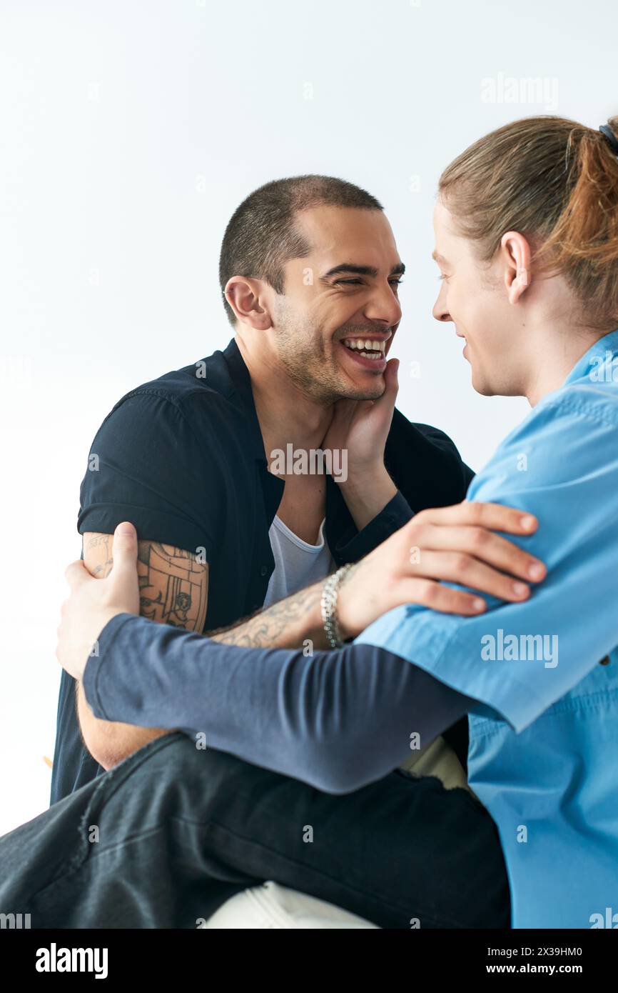 Two men sitting intertwined on top of each other Stock Photo - Alamy