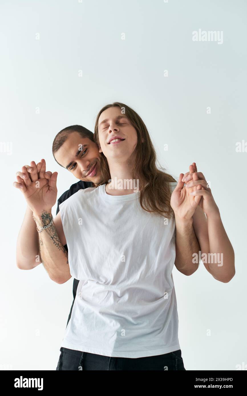 Two men fashionably pose for a picture Stock Photo - Alamy